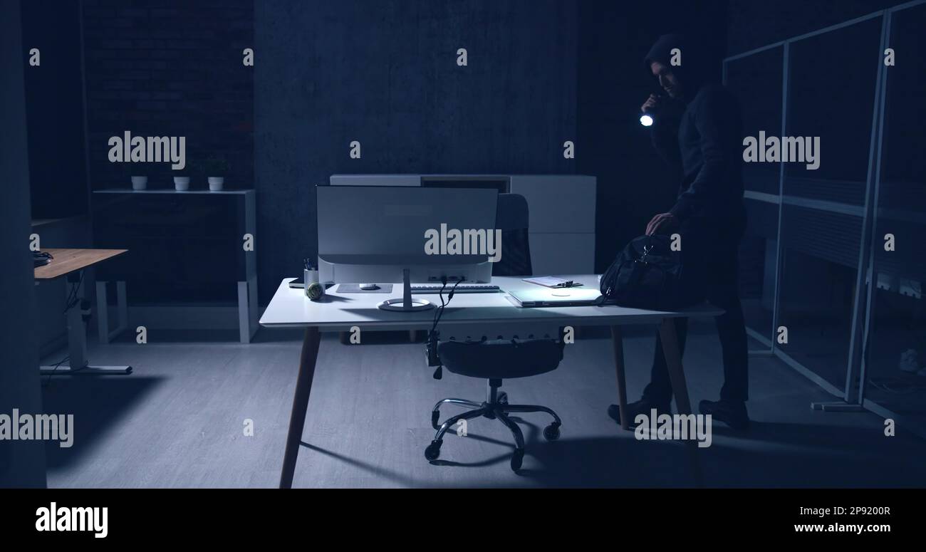 Thief Stealing Computer From Office At Night Stock Photo - Alamy