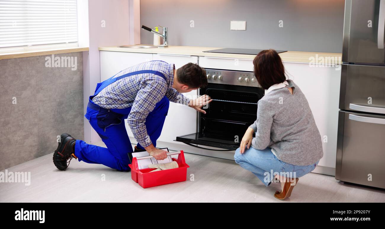 Maintenance Technician Servicing Oven Appliance. Kitchen Repair Stock ...