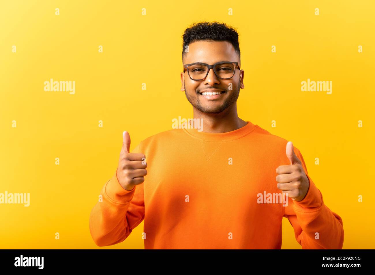 Smiling young 20s arab man cheerful and excited, showing thumbs up ...