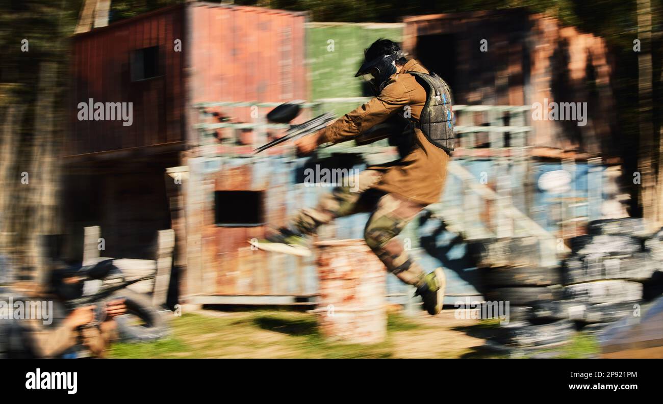 Paintball, man jump and aim gun at target, military tactics at shooting ... Paintball, man jump and aim gun at target, military tactics at shooting ...