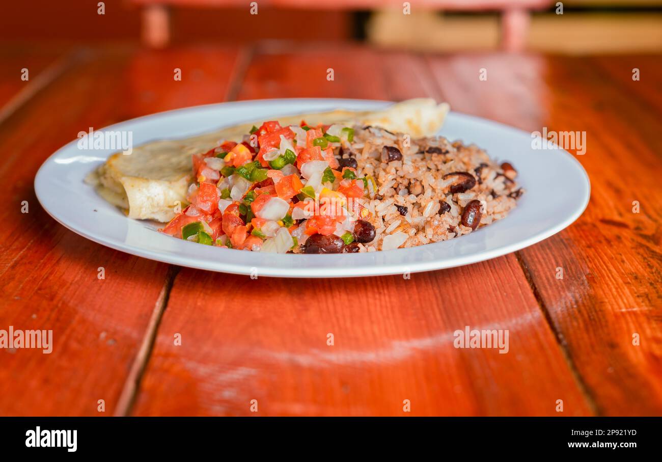 Traditional Gallo Pinto Meal with Pico de Gallo and quesillo served ...