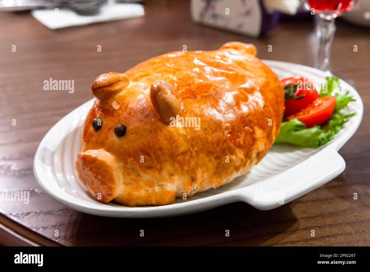 Pig shaped meat pie is on a table, close up photo with selective soft ...