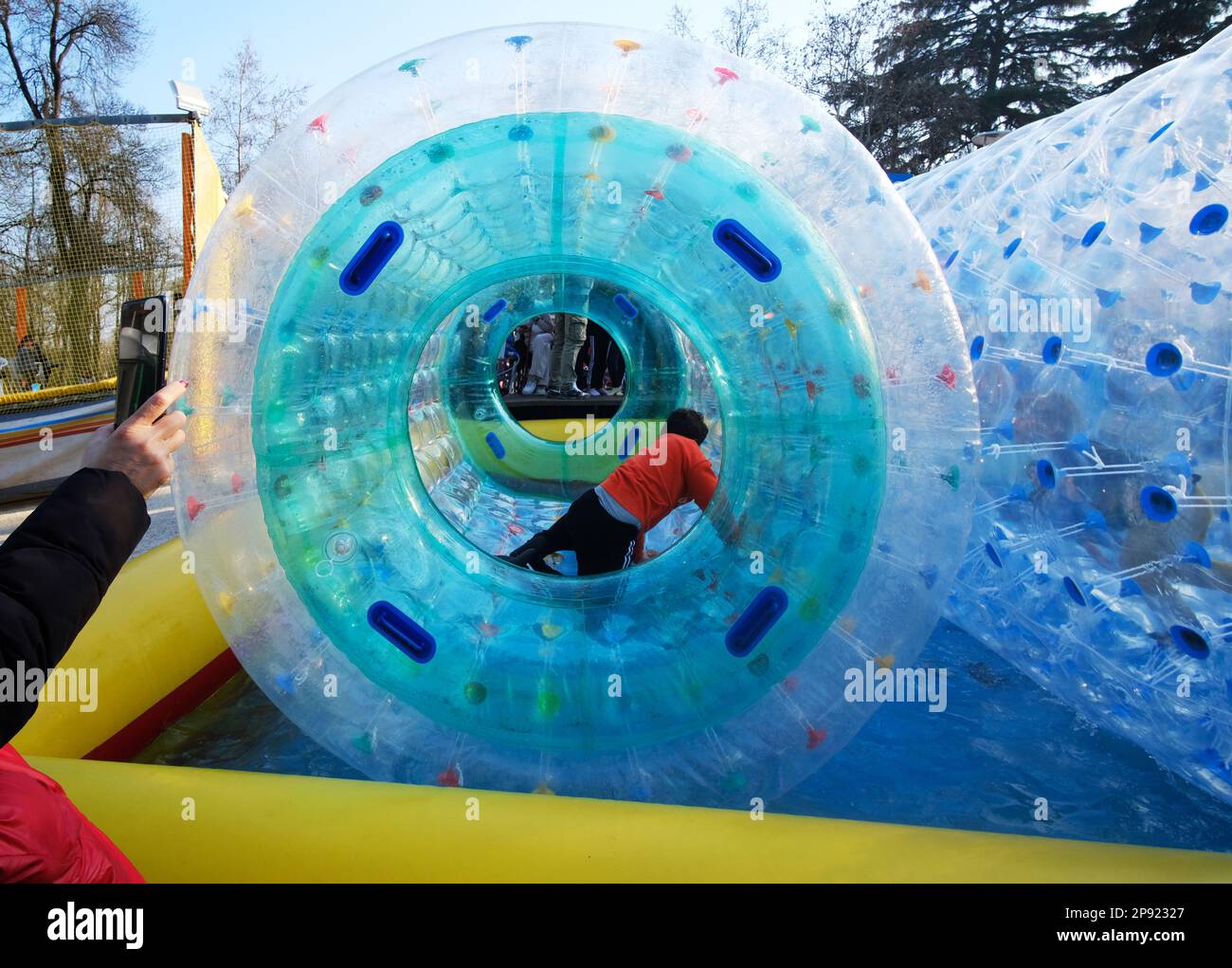 children playing inside bubble having fun in the Luna Park - Amusement ...