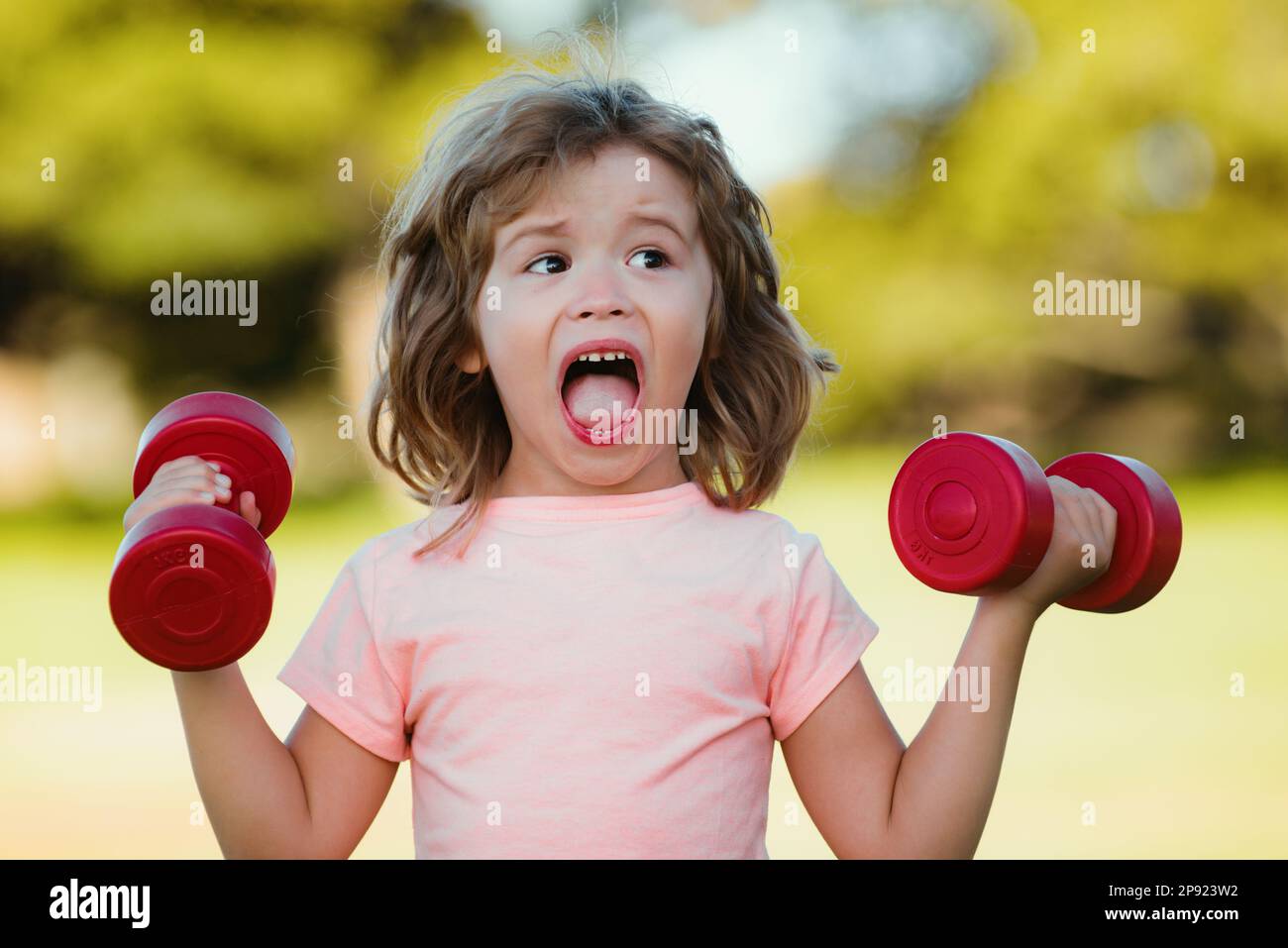 Kid with dumbbells in park. Child sport. Active boy, healthy lifestyle ...