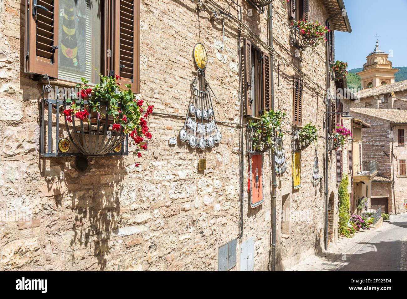 Spello, Italy - Circa June 2021: flowers in ancient street. Spello is ...