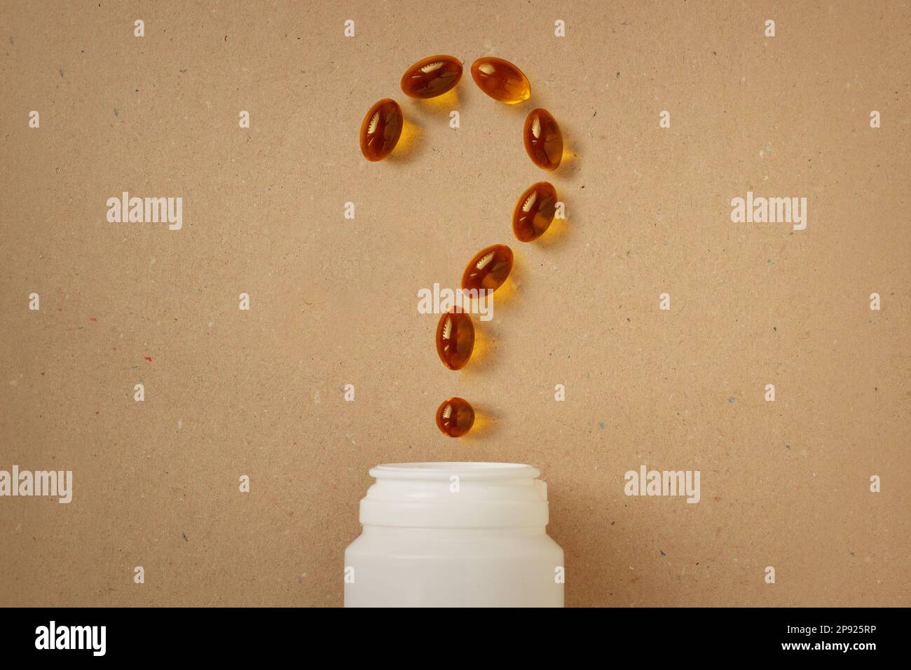 Question mark made of omega 3 Fish Oil capsules on recycled paper ...