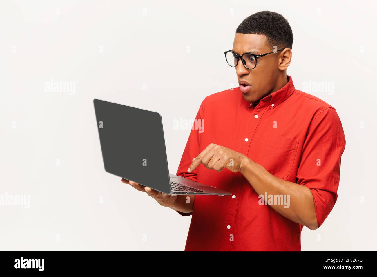 Shocked young African American man standing isolated on white wall ...