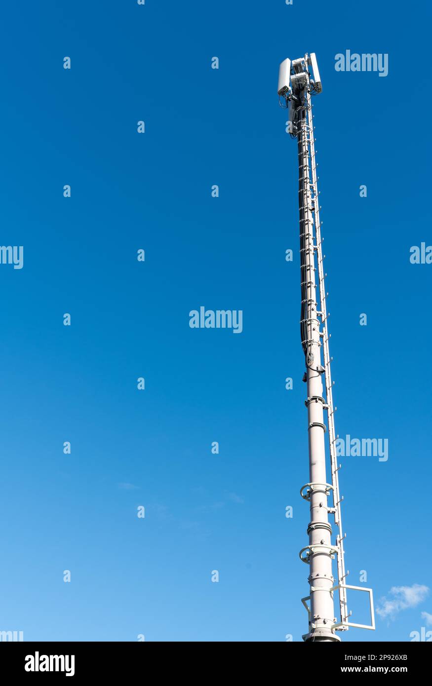 Vertical view of a tall antenna tower for mobile and cellular telephone ...