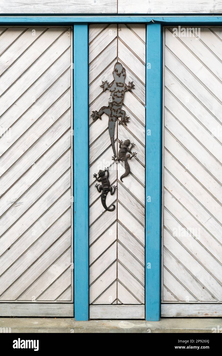 Detailed and close up view of a white wooden door with blue siding and ...