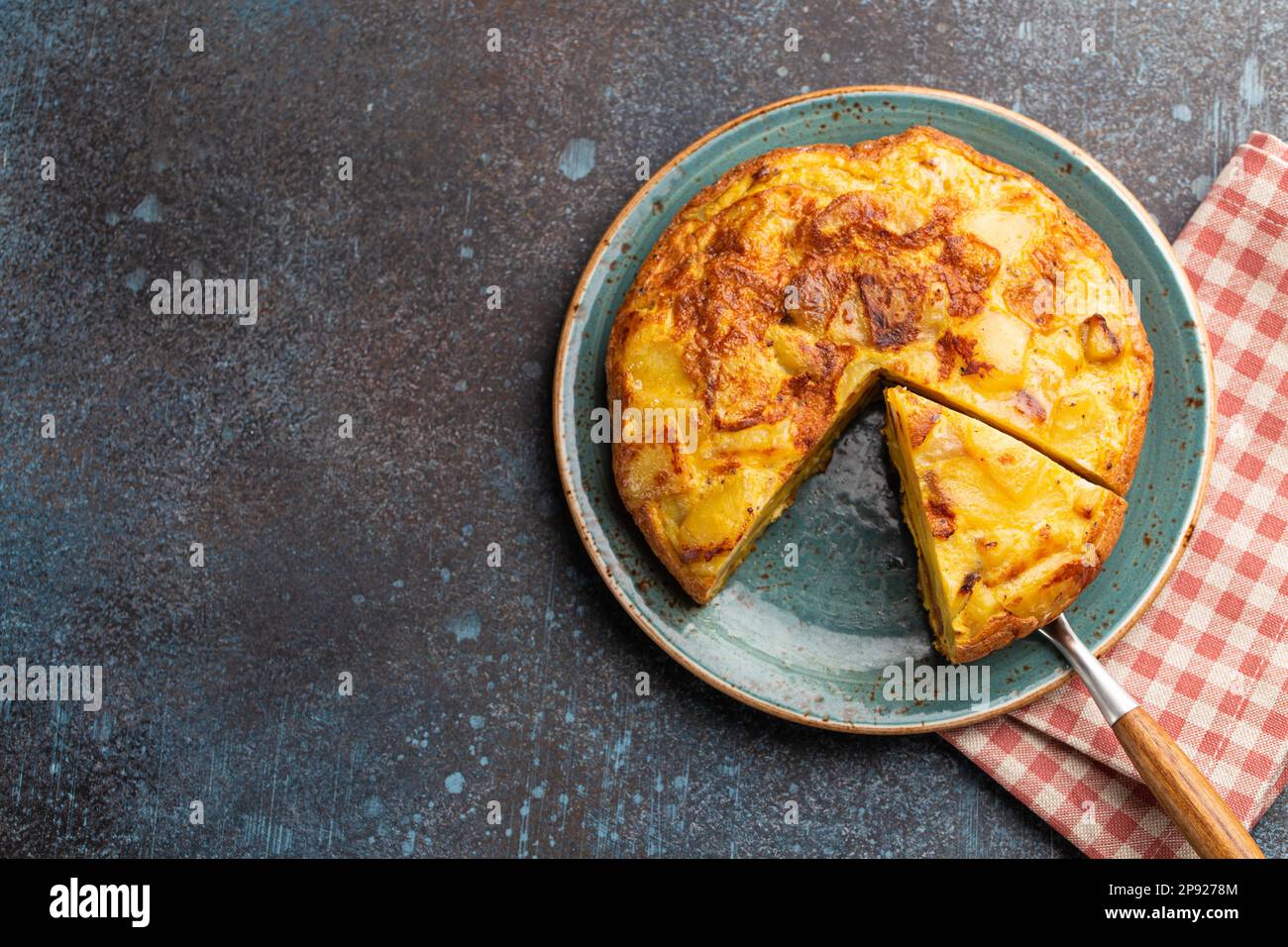 Homemade Spanish tortilla with one slice cut - omelette with potatoes ...