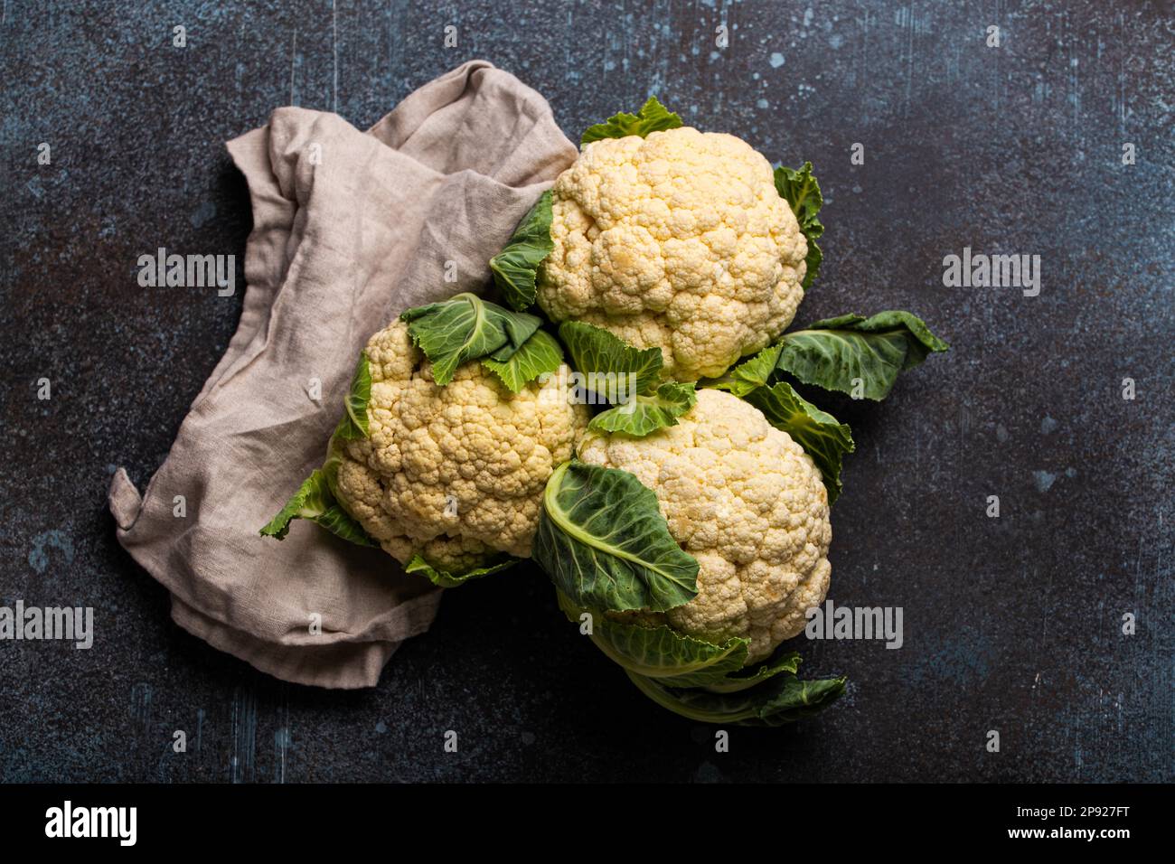 Fresh whole raw organic white cauliflower on dark stone vintage ...