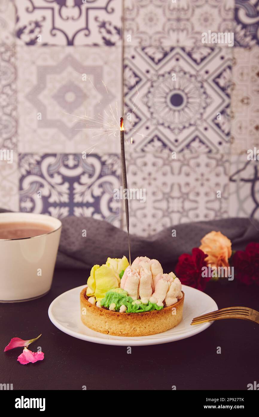 Floral french birthday tart with flowers and coffee. Ceramic tile ...