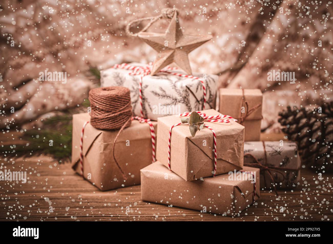 Pile of Christmas wrapped presents with twine string roll, fir tree ...