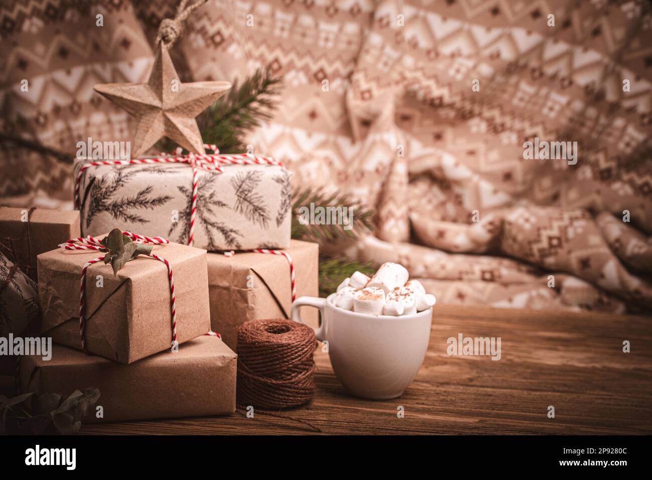 Pile of Christmas wrapped presents with twine string roll, fir tree ...