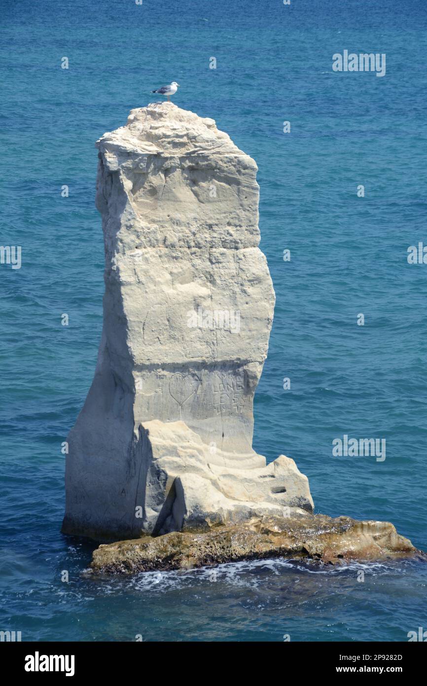 The white stacks rise in the blue sea of Noto marinas on the Ionian sea ...