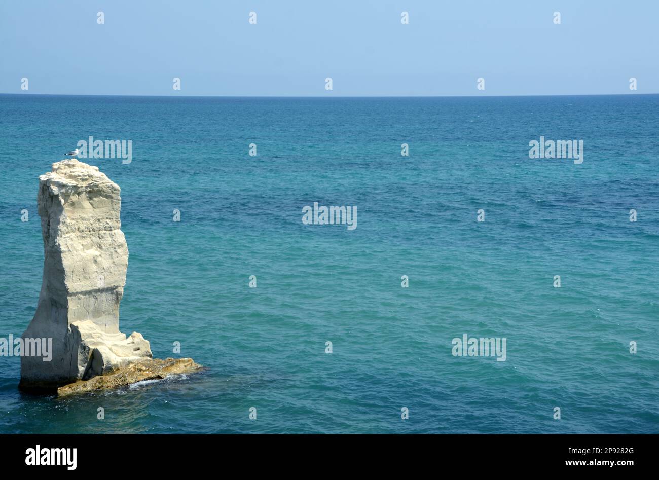 The white stacks rise in the blue sea of Noto marinas on the Ionian sea ...