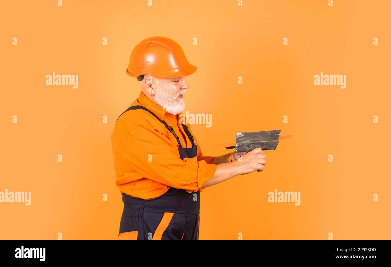 He needs little break. Plasterer in working uniform plastering. man ...