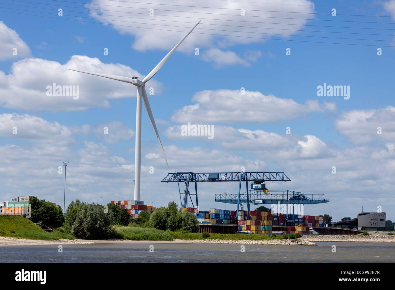 Port view with large Dutch inland shipping industry on river Maas ...