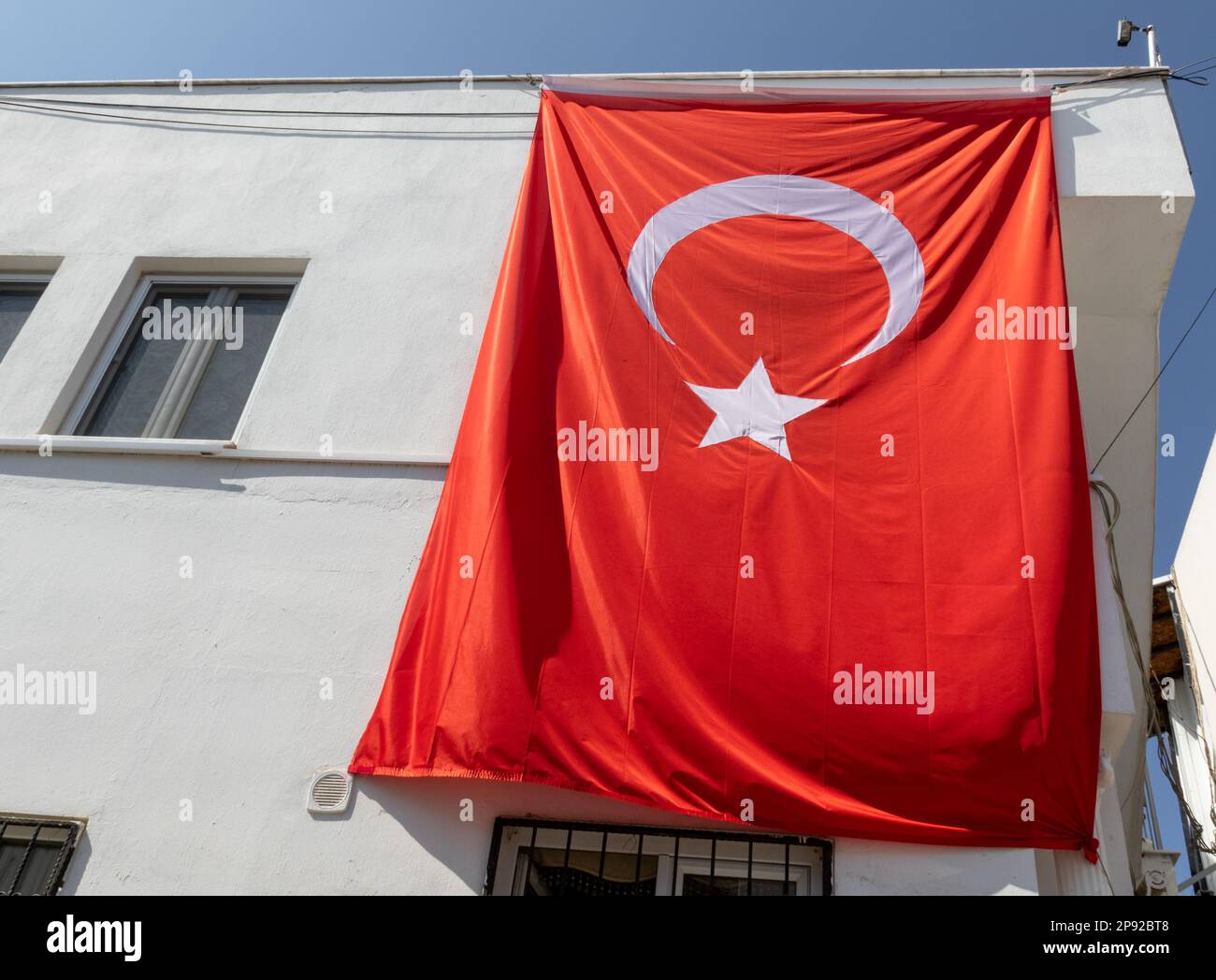 Turkish flag hanging from a white building Stock Photo - Alamy
