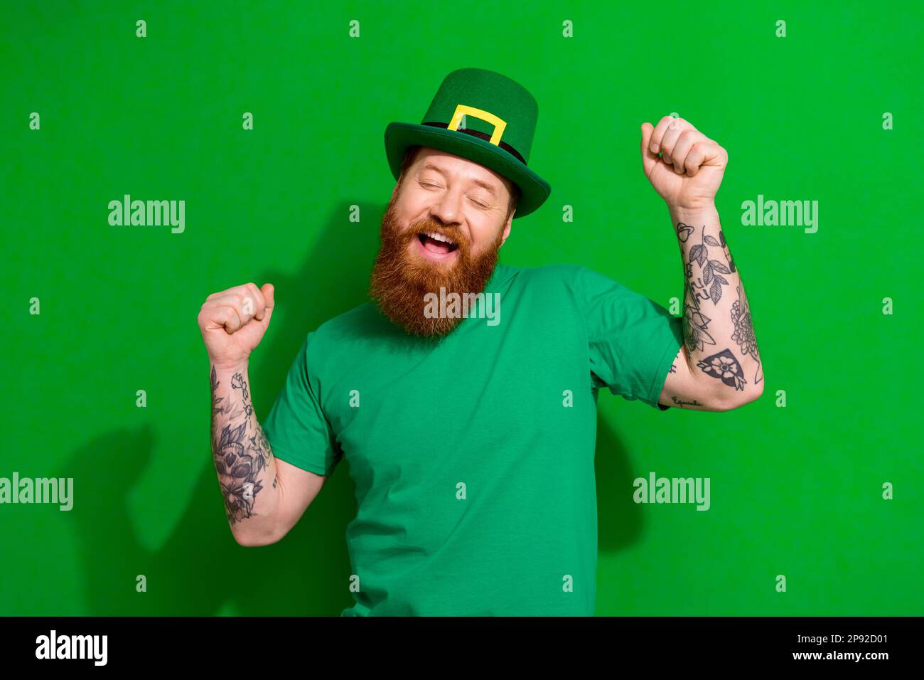 Photo of cool lucky man wear t-shirt arms headwear rising fists ...