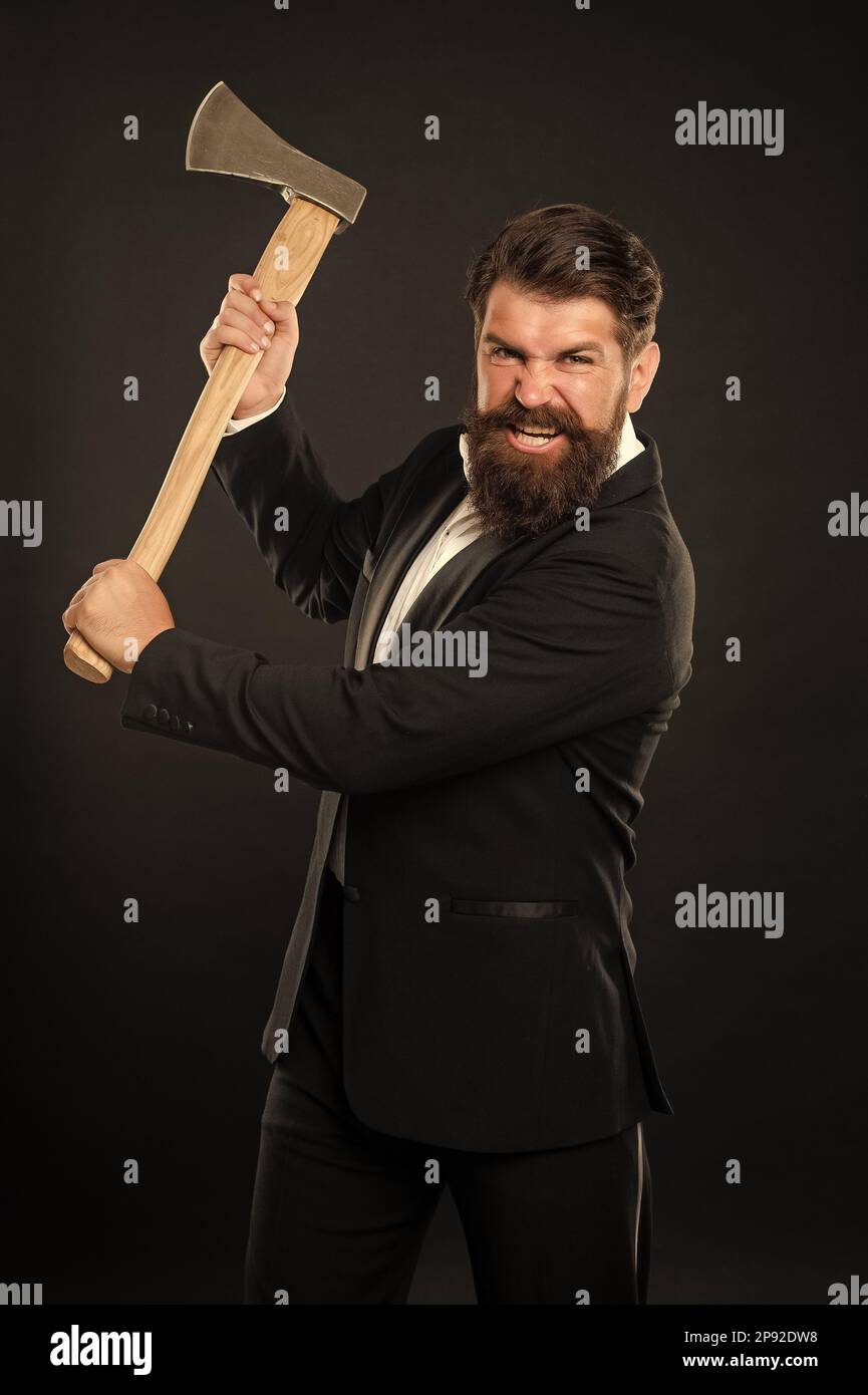 Angry bearded man in suit threatening with axe dark background, anger ...