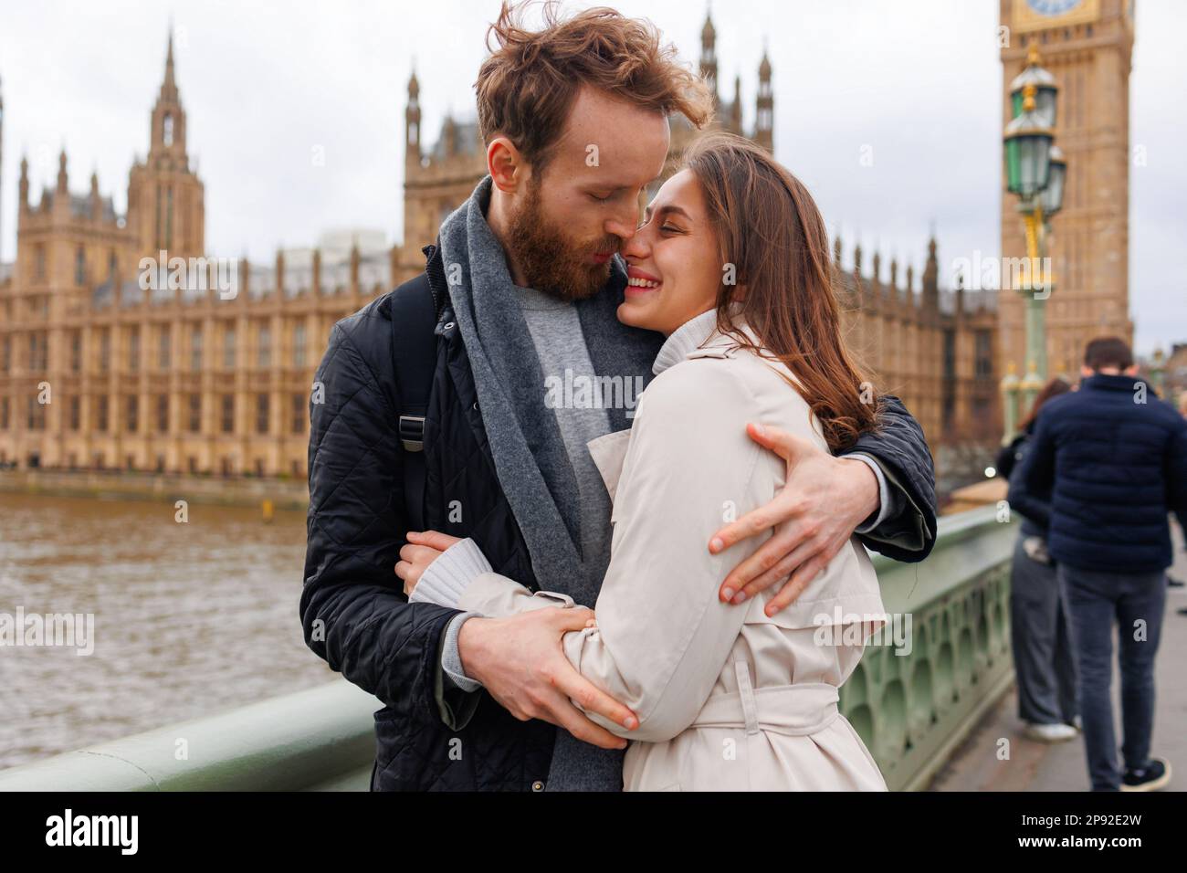 Happy young couple kissing near Big Ben tower Stock Photo - Alamy