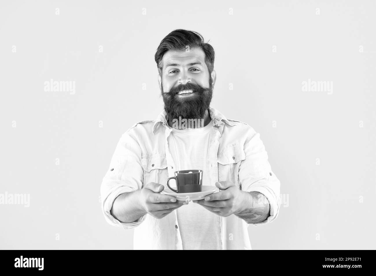 Happy caucasian guy smile giving tea cup yellow background, hot drink ...