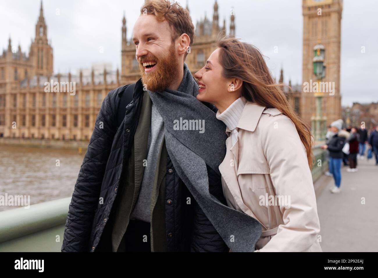 Happy young couple walks holding hands against the background of London ...