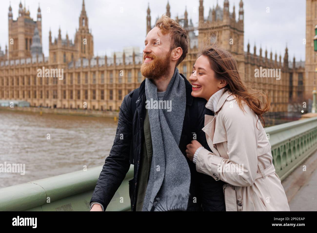 Happy young couple walks holding hands against the background of London ...