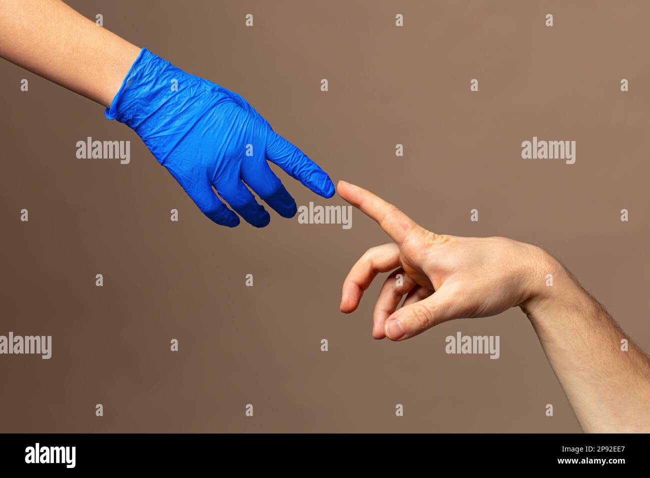 Male and female hands in medical gloves stretch to each other. Help ...
