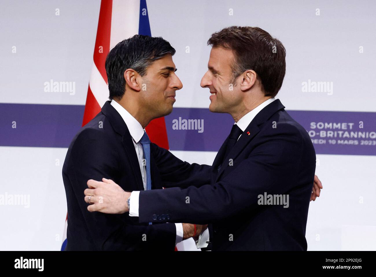 French President Emmanuel Macron, right, hugs British Prime Minister ...