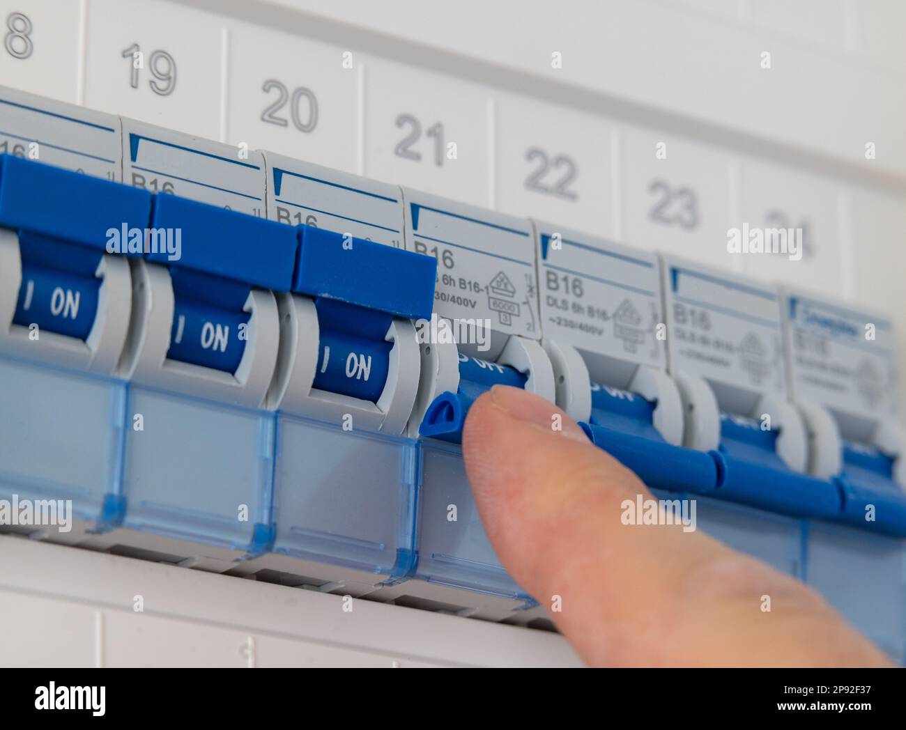 Technician switches on several fuse in a fuse box of a private house ...