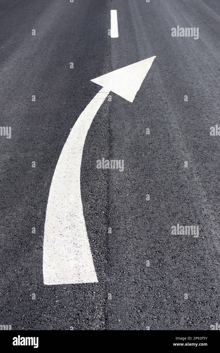 Traffic sign painted on the asphalt indicating curves Stock Photo - Alamy