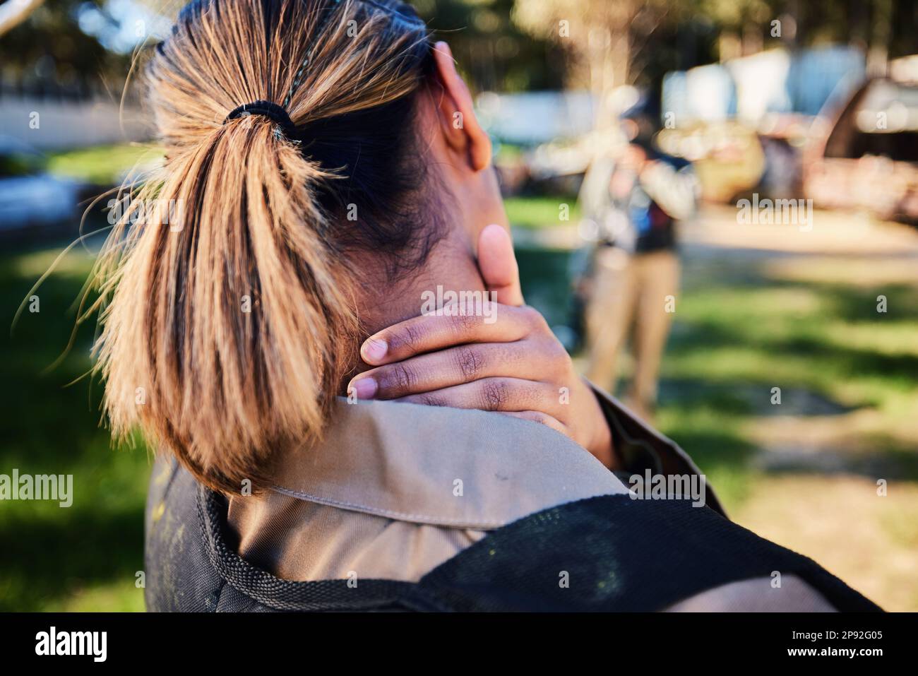 Closeup, neck pain and hand of woman with injury in paintball, sports ...