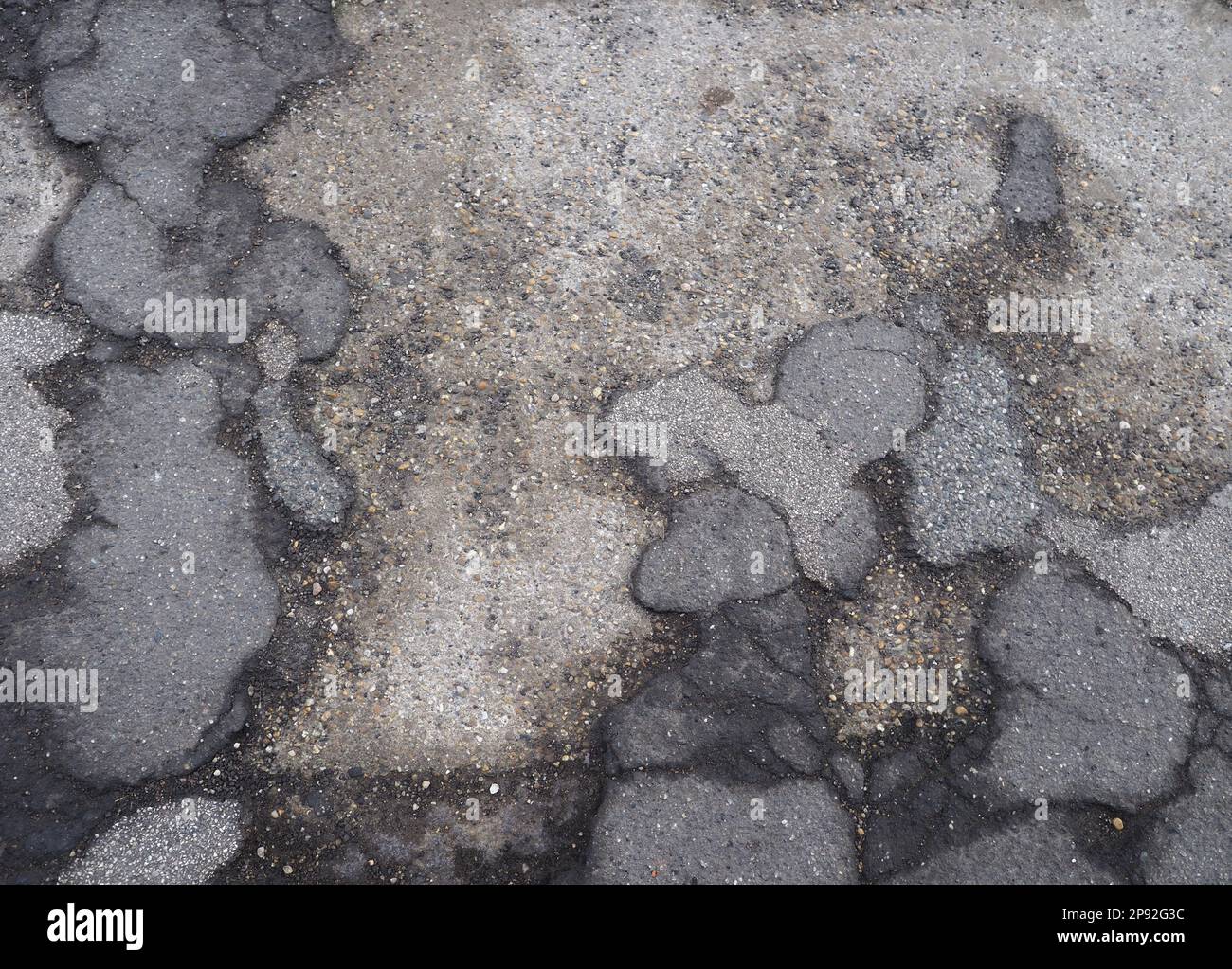 asphalt damage on derelict pavement floor showing underlying concrete ...