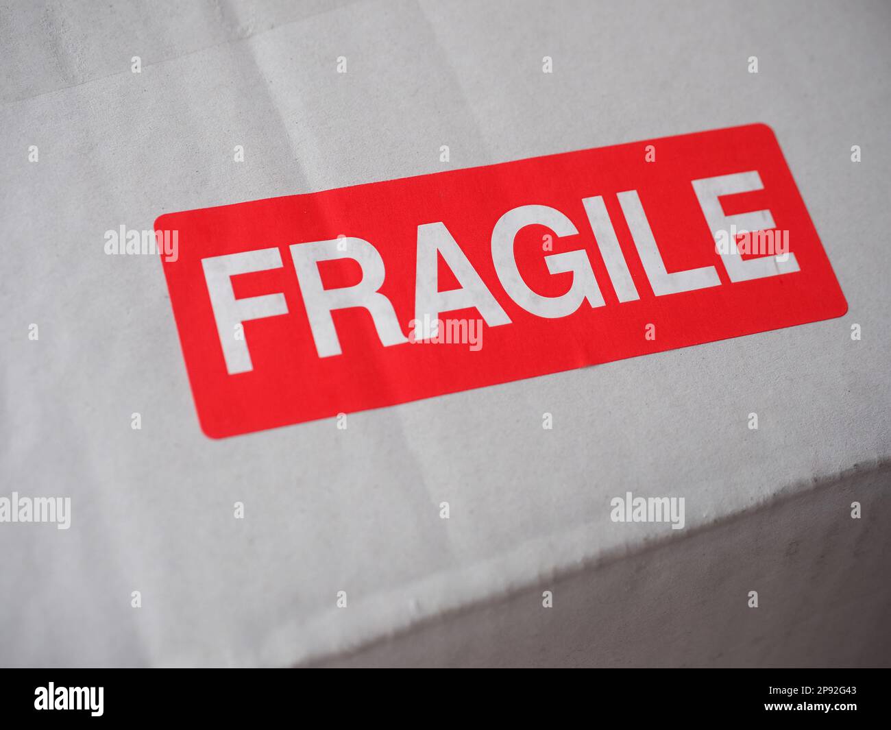 fragile warning sign label tag on a cardboard box Stock Photo - Alamy