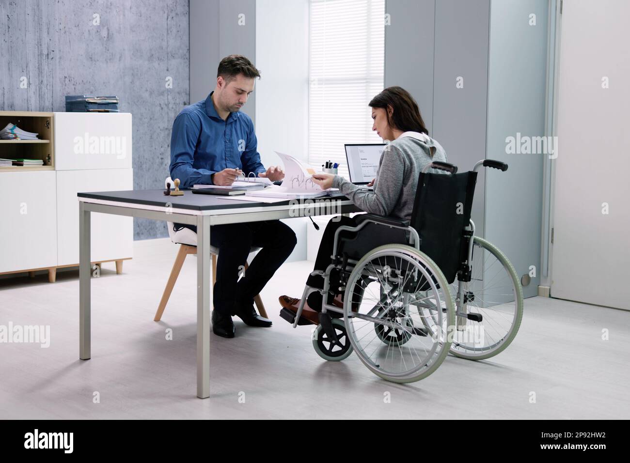 Businesswoman ith Disability Sitting On Wheelchair In Office Stock ...