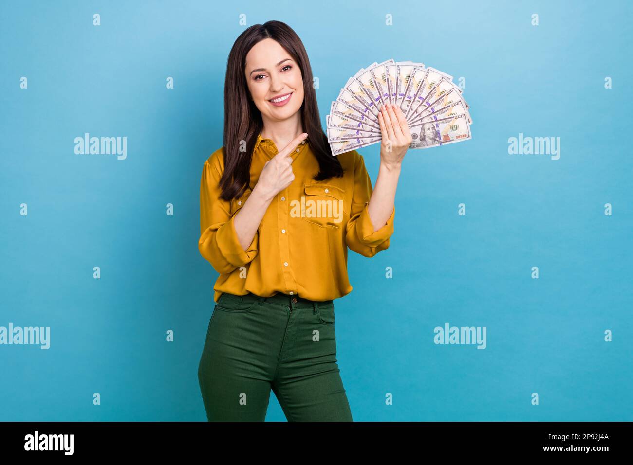 Photo of cheerful influencer woman pointing finger earnings dollars ...