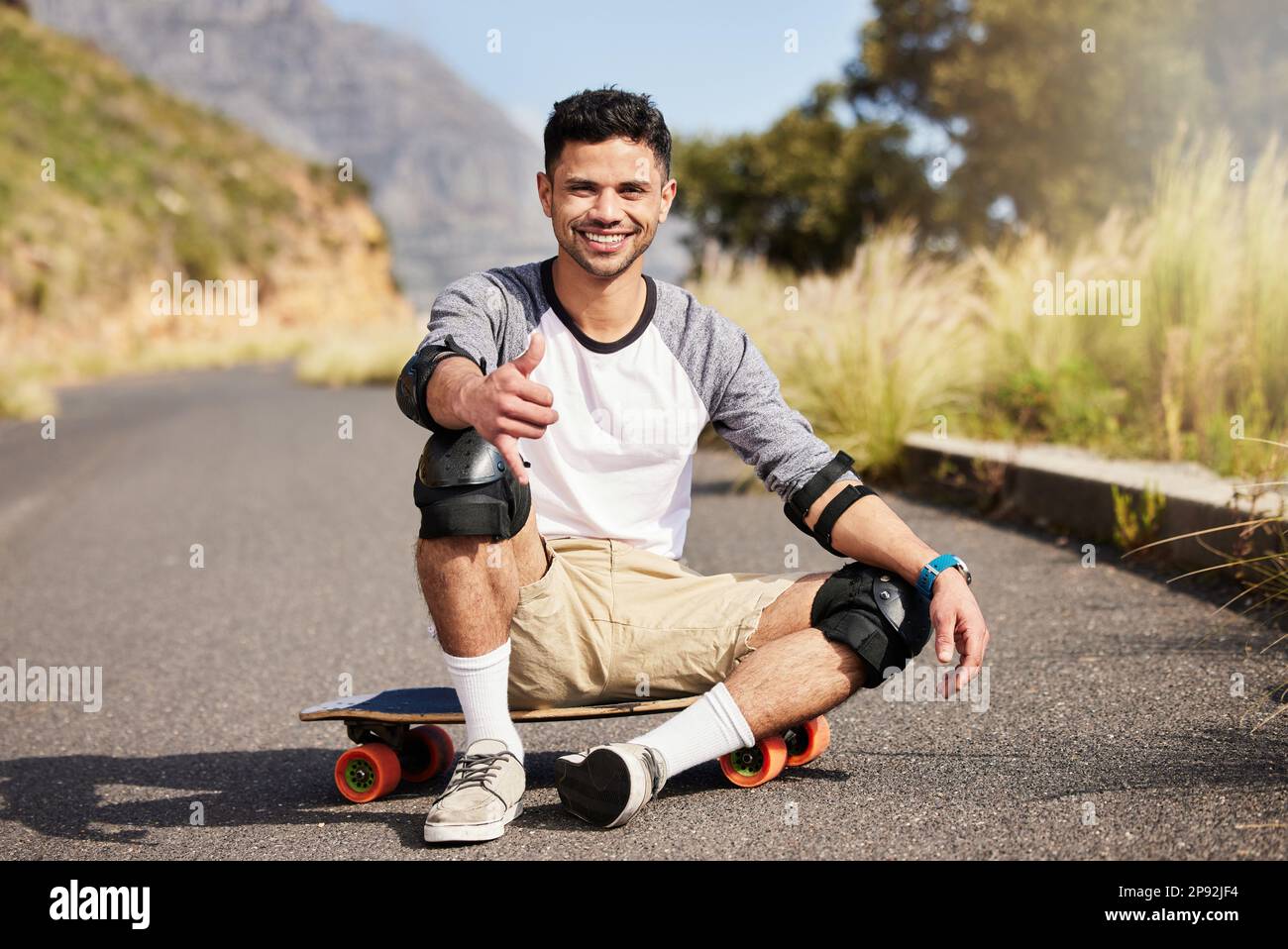 Young man outdoor, skateboard and skater with fitness on country road ...