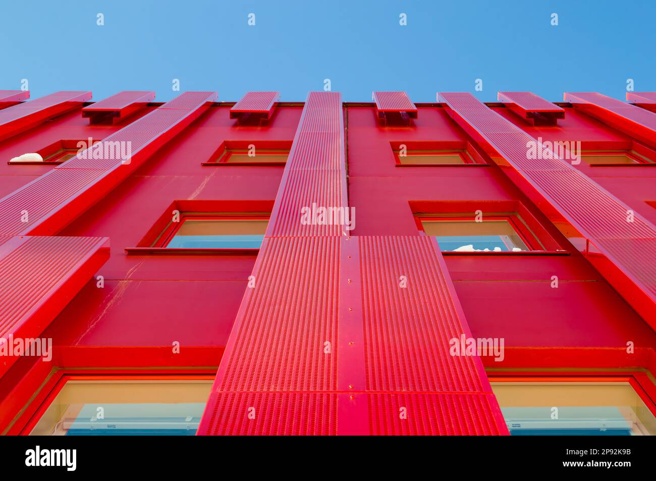 Modern red architectural office building. Metal sheets covering the ...