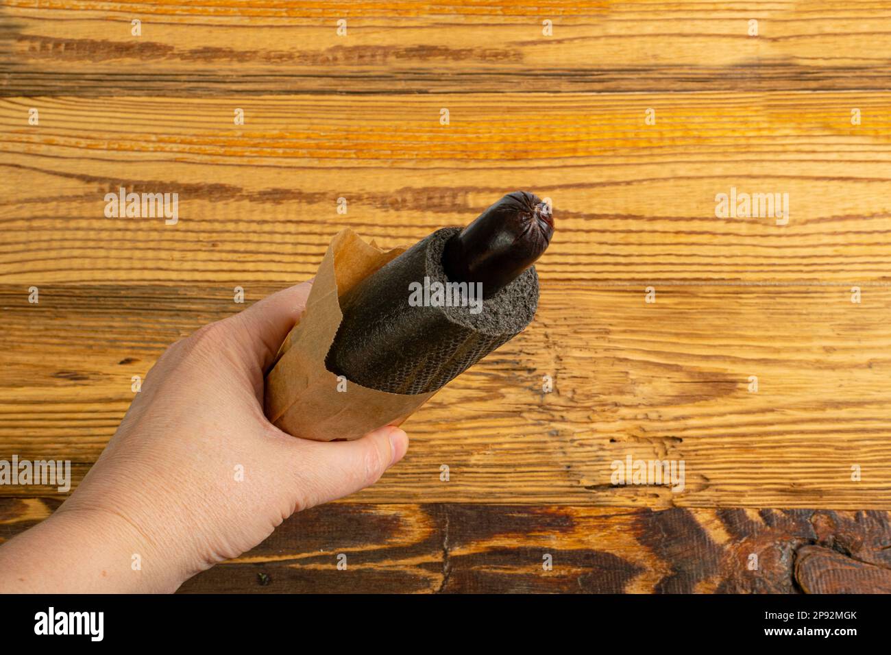 Black Hotdog on Wood Background, Dark Sausage Inside a Grilled Bun ...