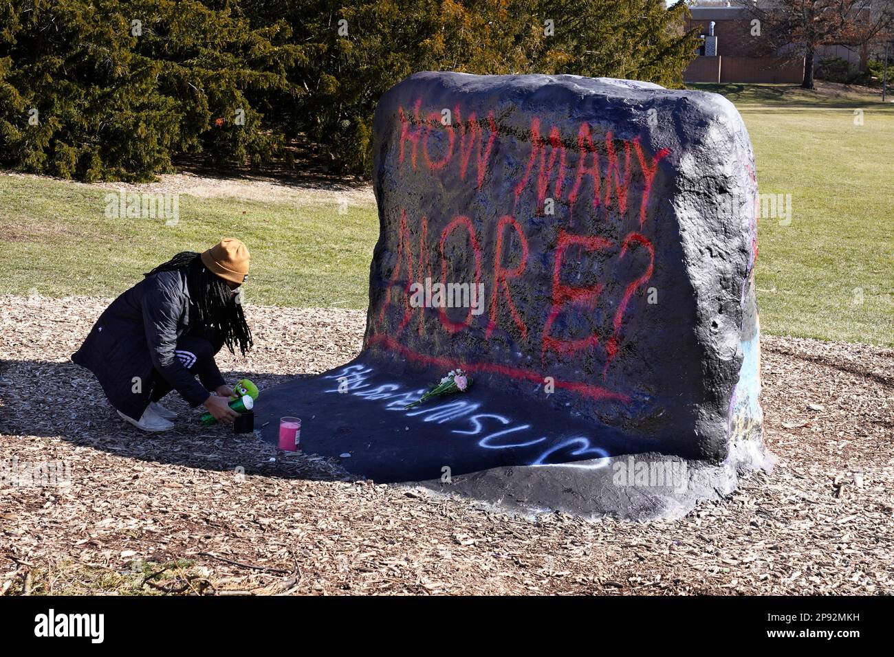 FILE - Michigan State University student Devin Crawford places flowers ...