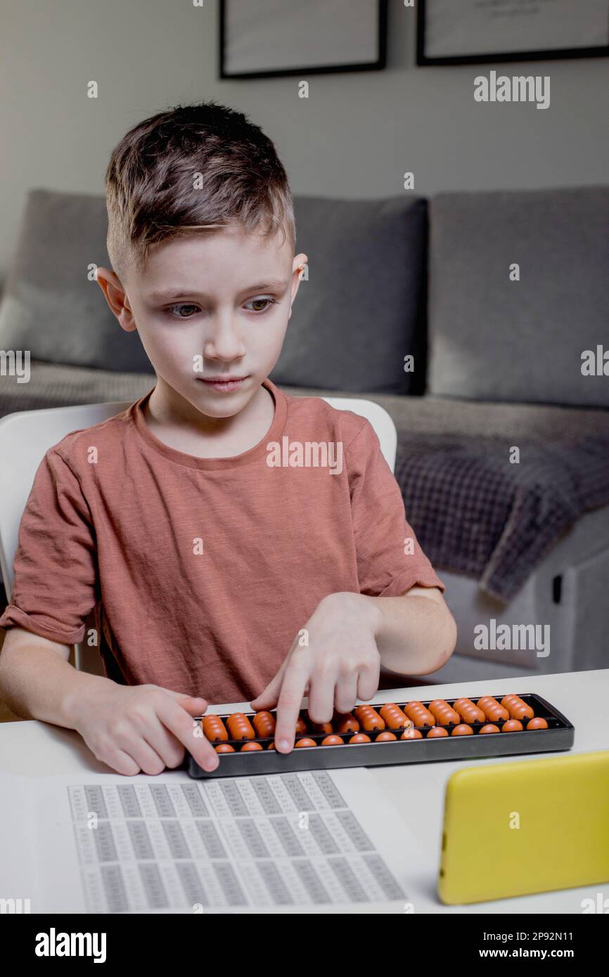 Little boy counting with the help of mental arithmetic. Mathematics in ...
