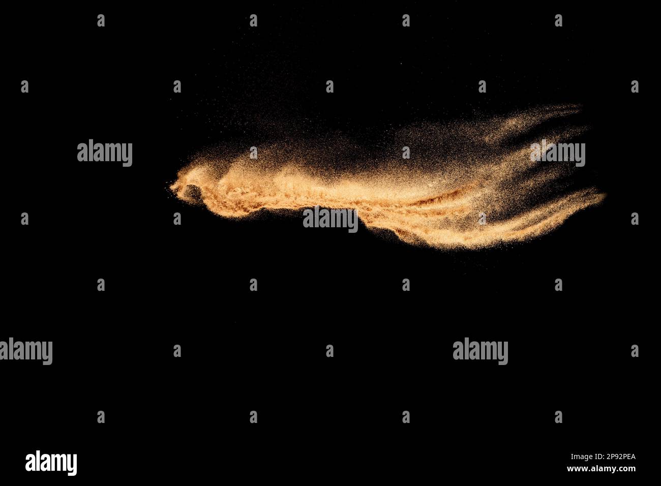 Sand explosion isolated on black background. Freeze motion of sandy ...