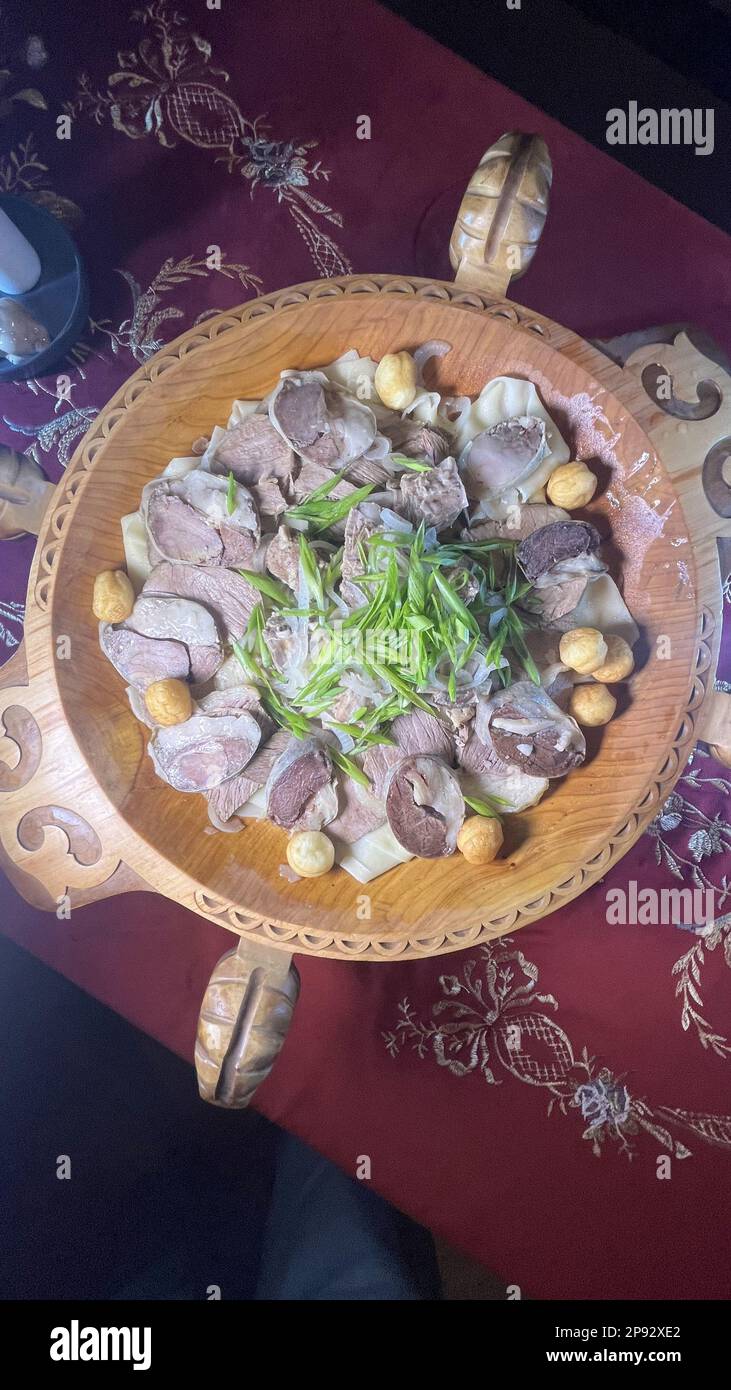 Kazakh traditional dish beshbarmak on the table Stock Photo - Alamy