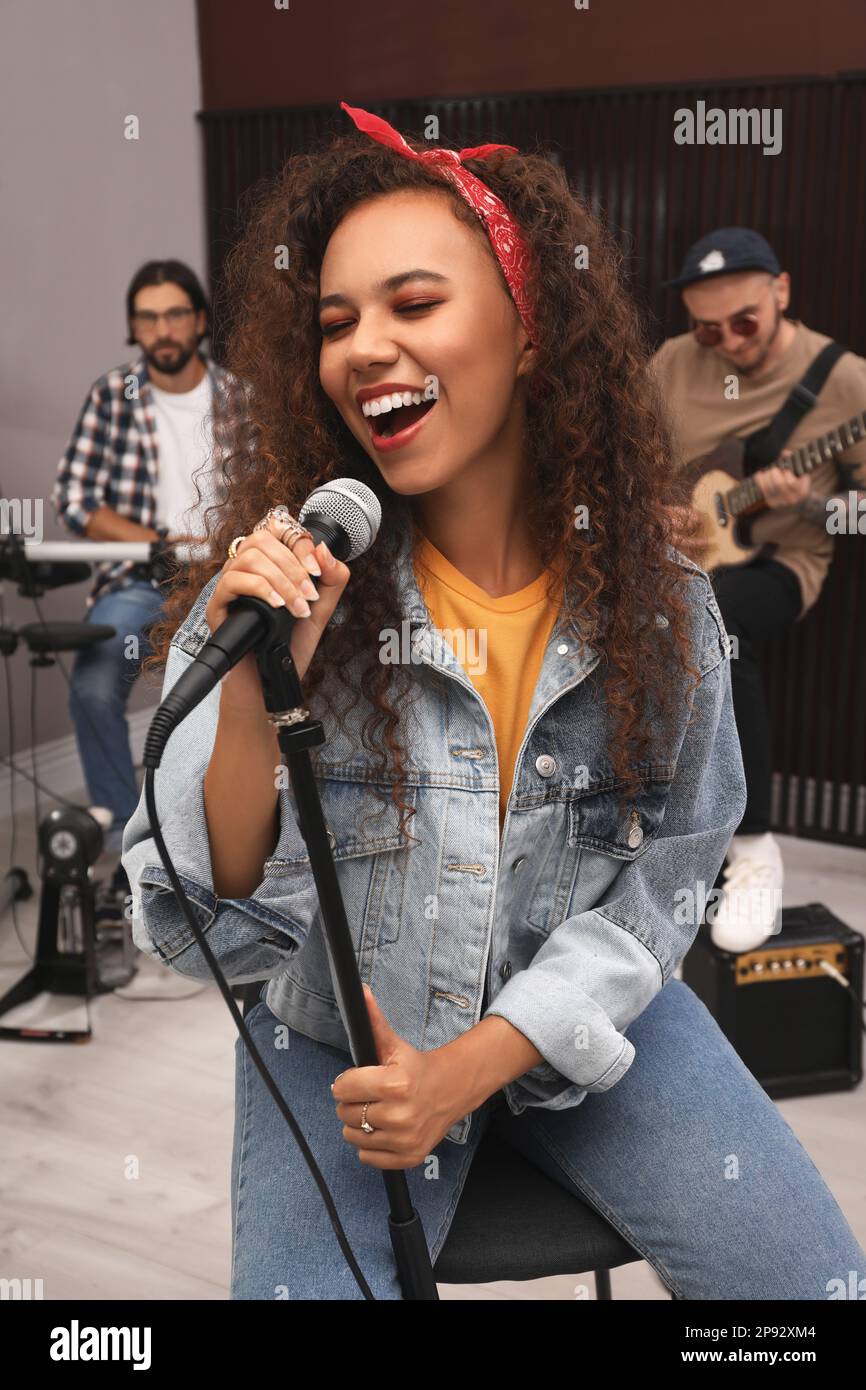 Music band performing in modern recording studio Stock Photo - Alamy