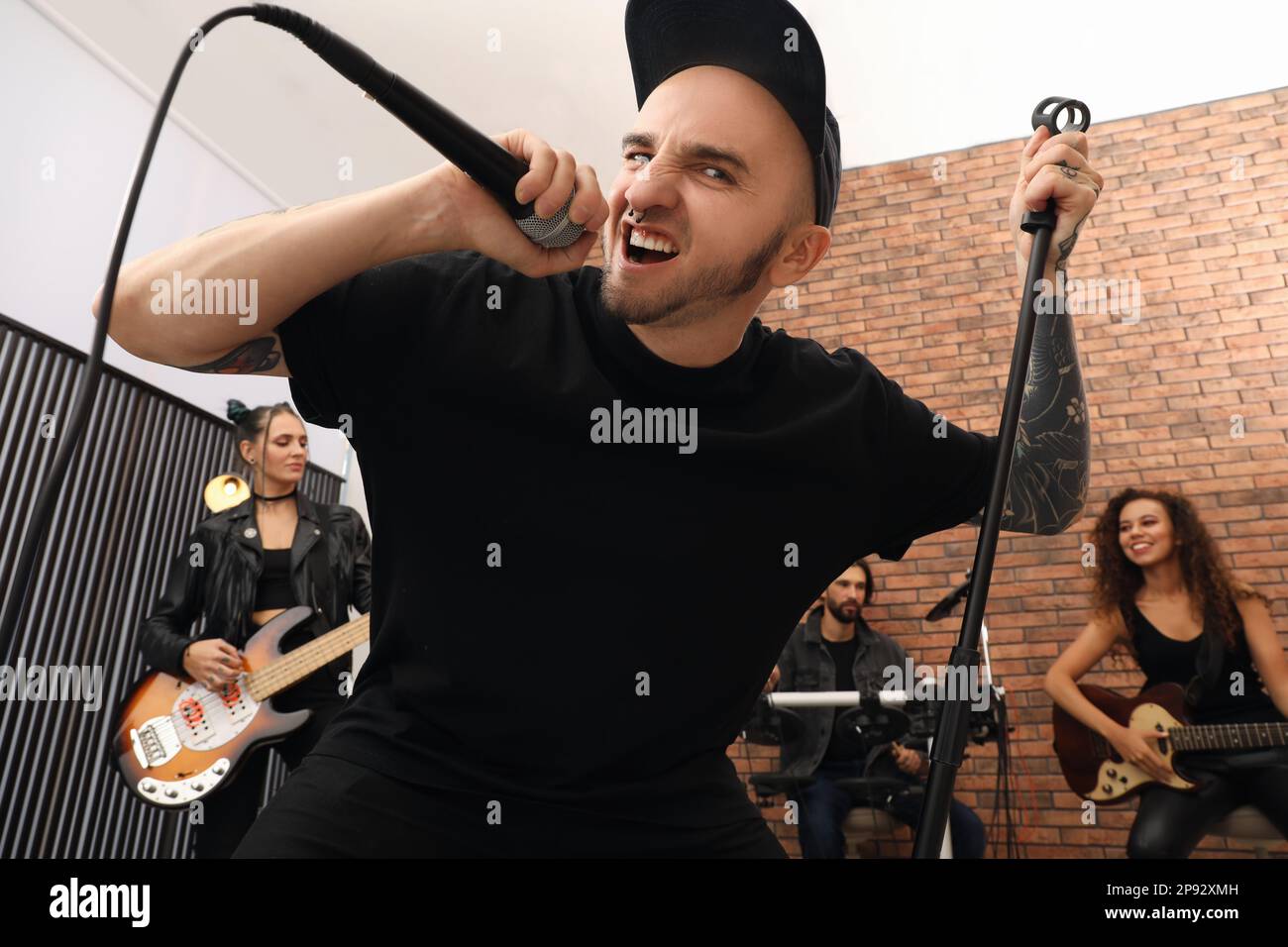 Music band performing in modern recording studio Stock Photo - Alamy