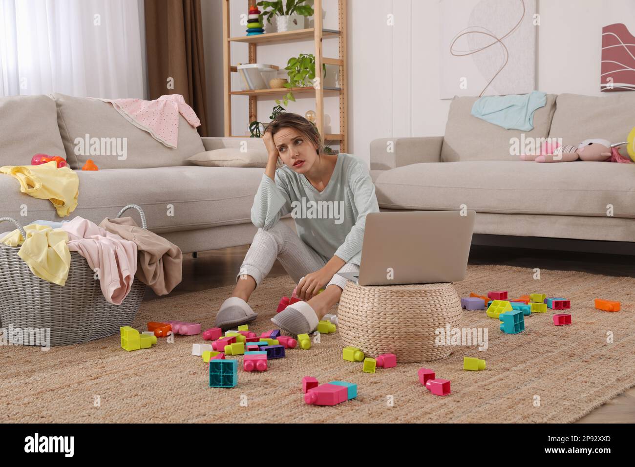 Girl sitting on messy clothes hi-res stock photography and images - Alamy
