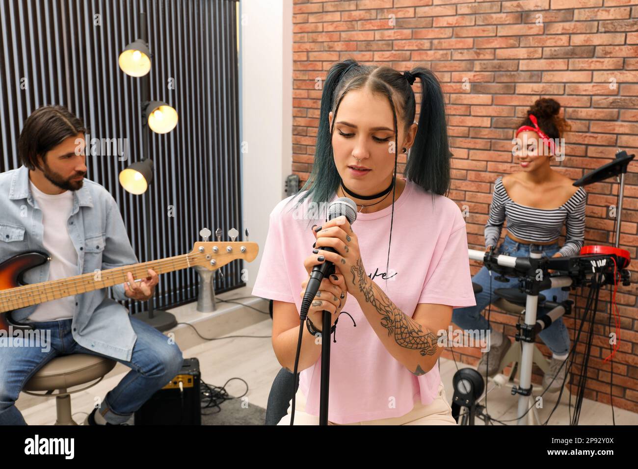 Music band performing in modern recording studio Stock Photo - Alamy
