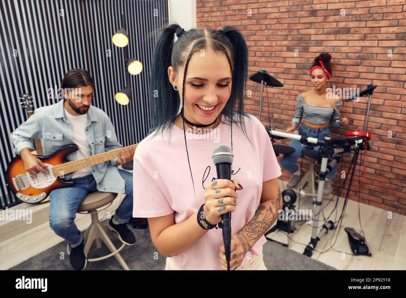 Music band performing in modern recording studio Stock Photo - Alamy